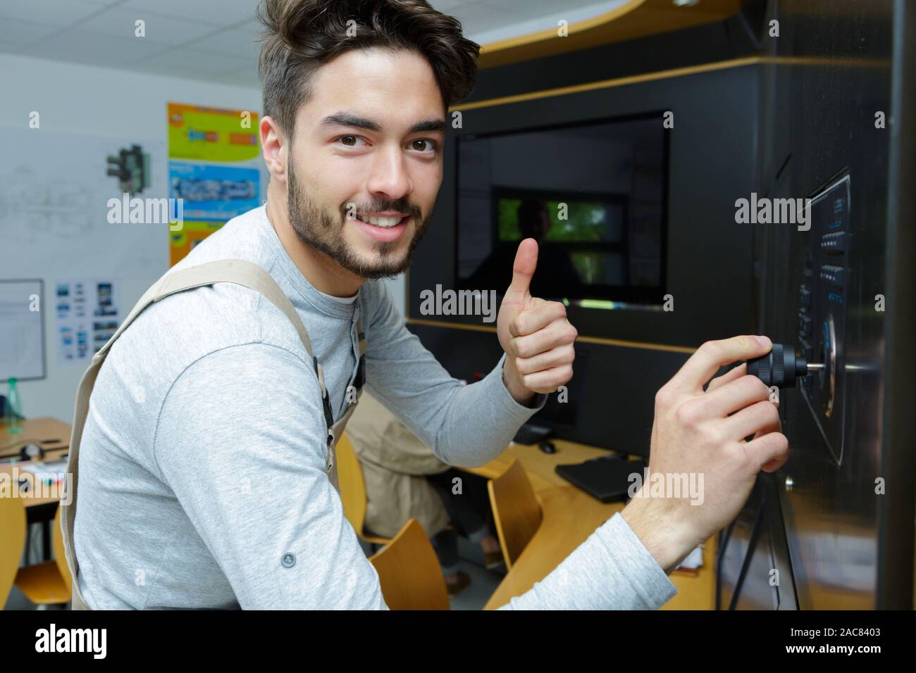 male electrical engineer showing ok sign Stock Photo - Alamy