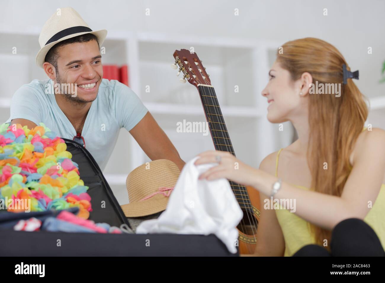 a couple is swapping hats Stock Photo - Alamy