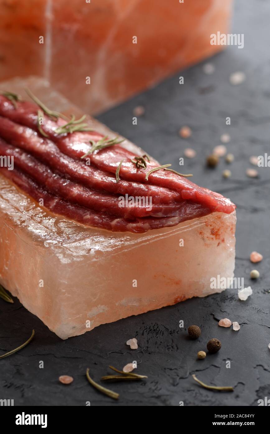 Cooking on salt block concept. Raw Black Angus beef marinated on ...