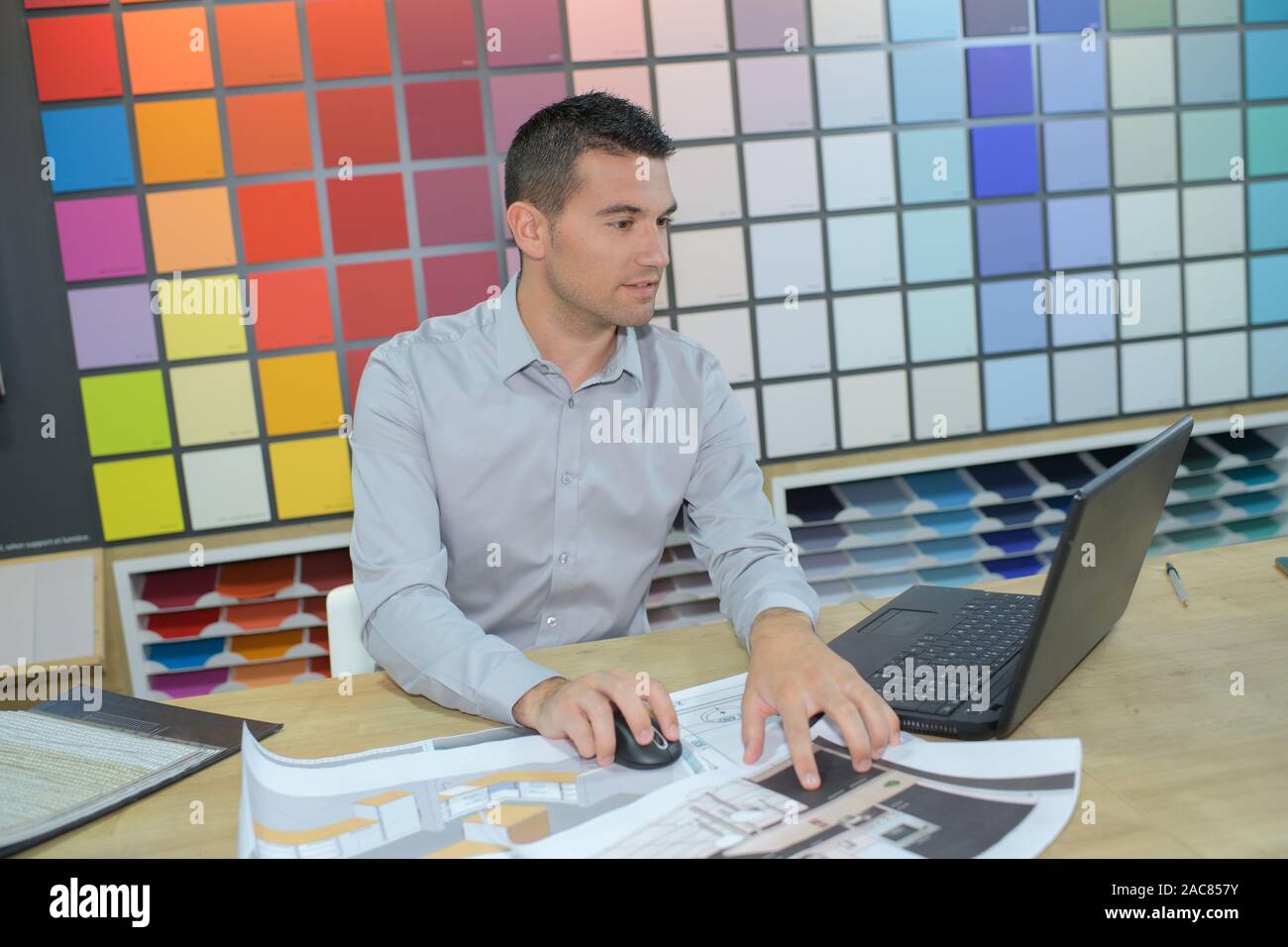 interior designer sat at desk Stock Photo - Alamy