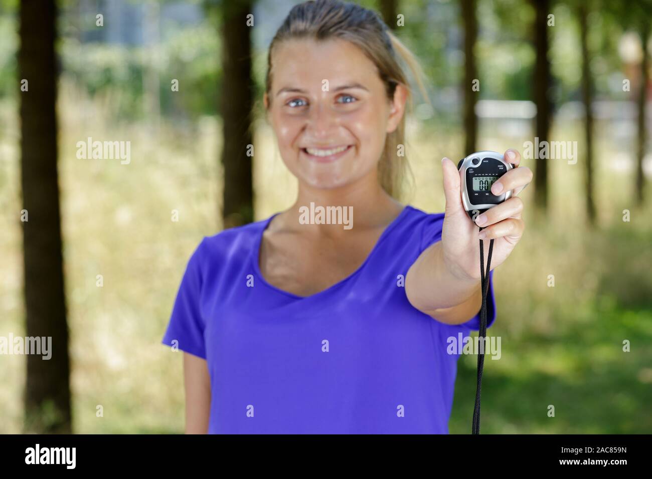 a woman holding stop watch Stock Photo - Alamy