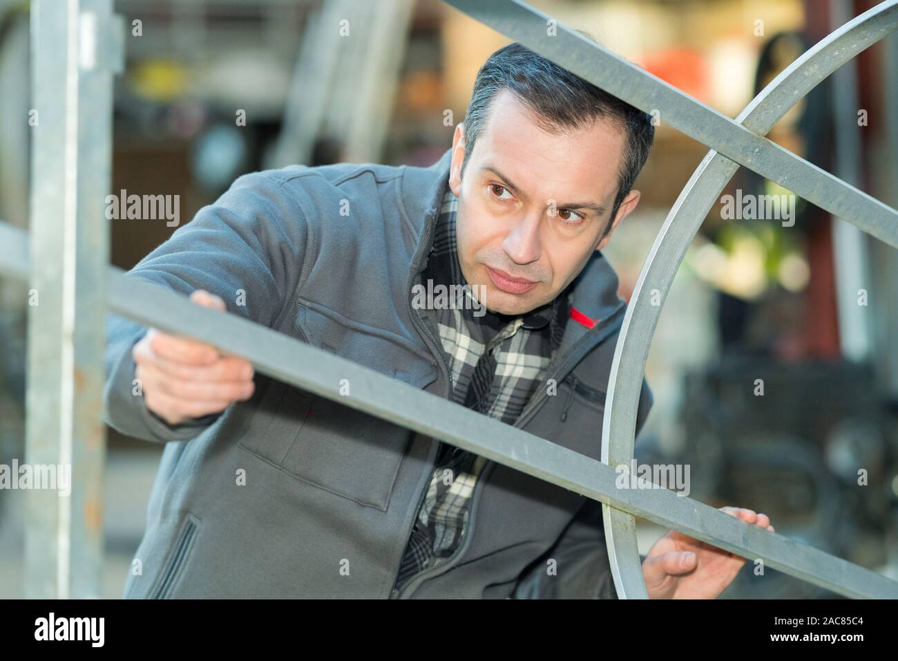 engineer measuring metal objects in a factory Stock Photo - Alamy