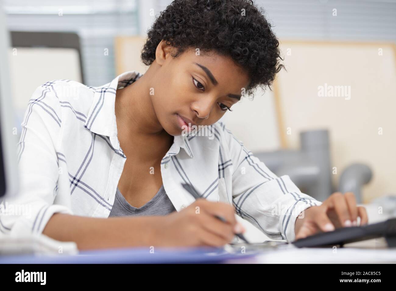 a female engineer writing notes Stock Photo - Alamy