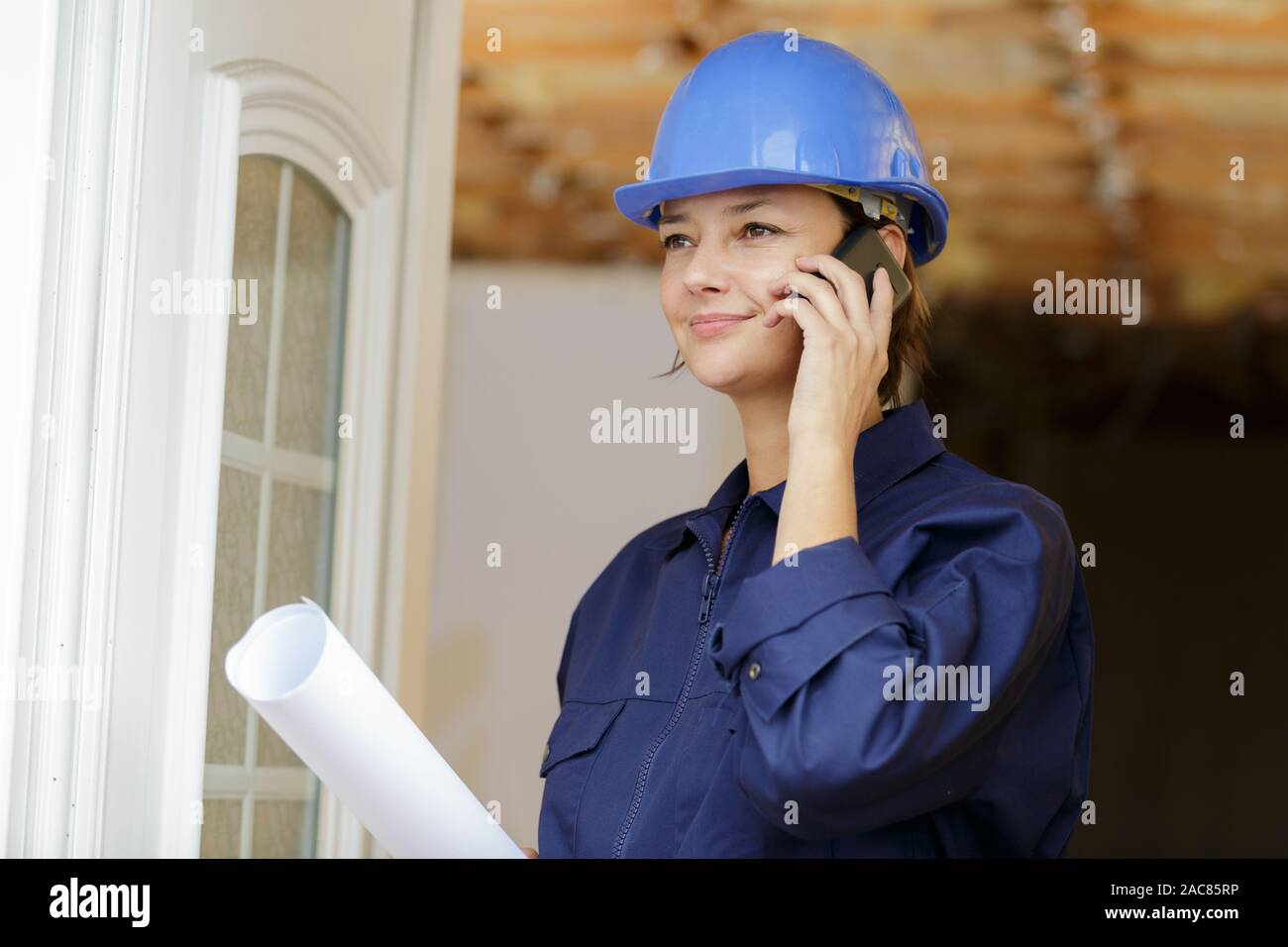 Female builder on cell hi-res stock photography and images - Alamy