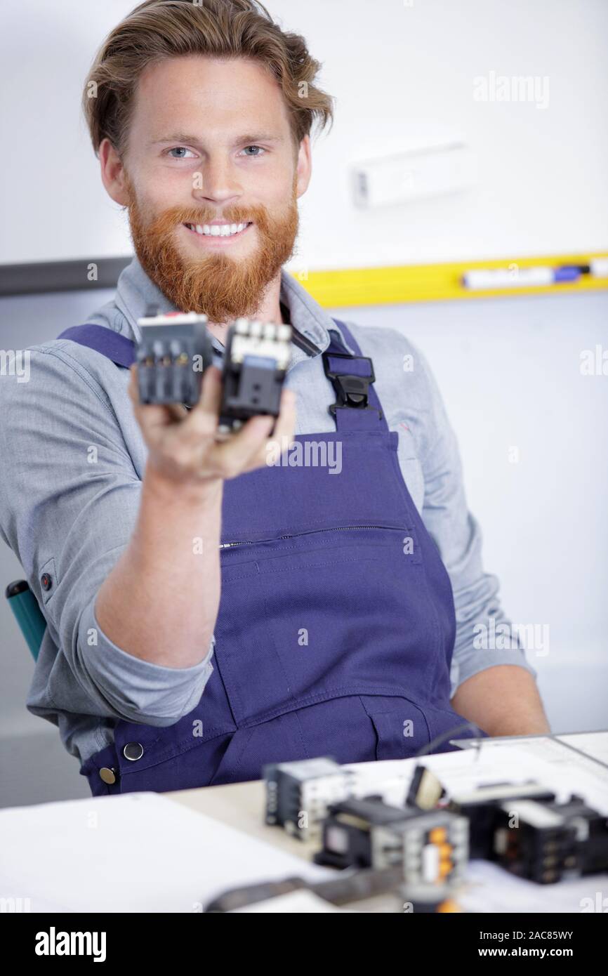 electrician showing electronical devices to the camera Stock Photo - Alamy