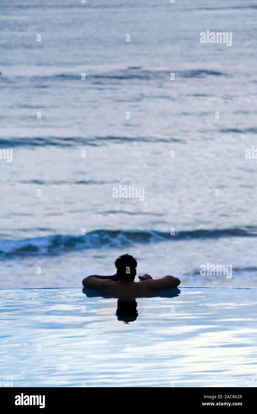 Man Relaxing In Infinity Pool High Resolution Stock Photography and ...
