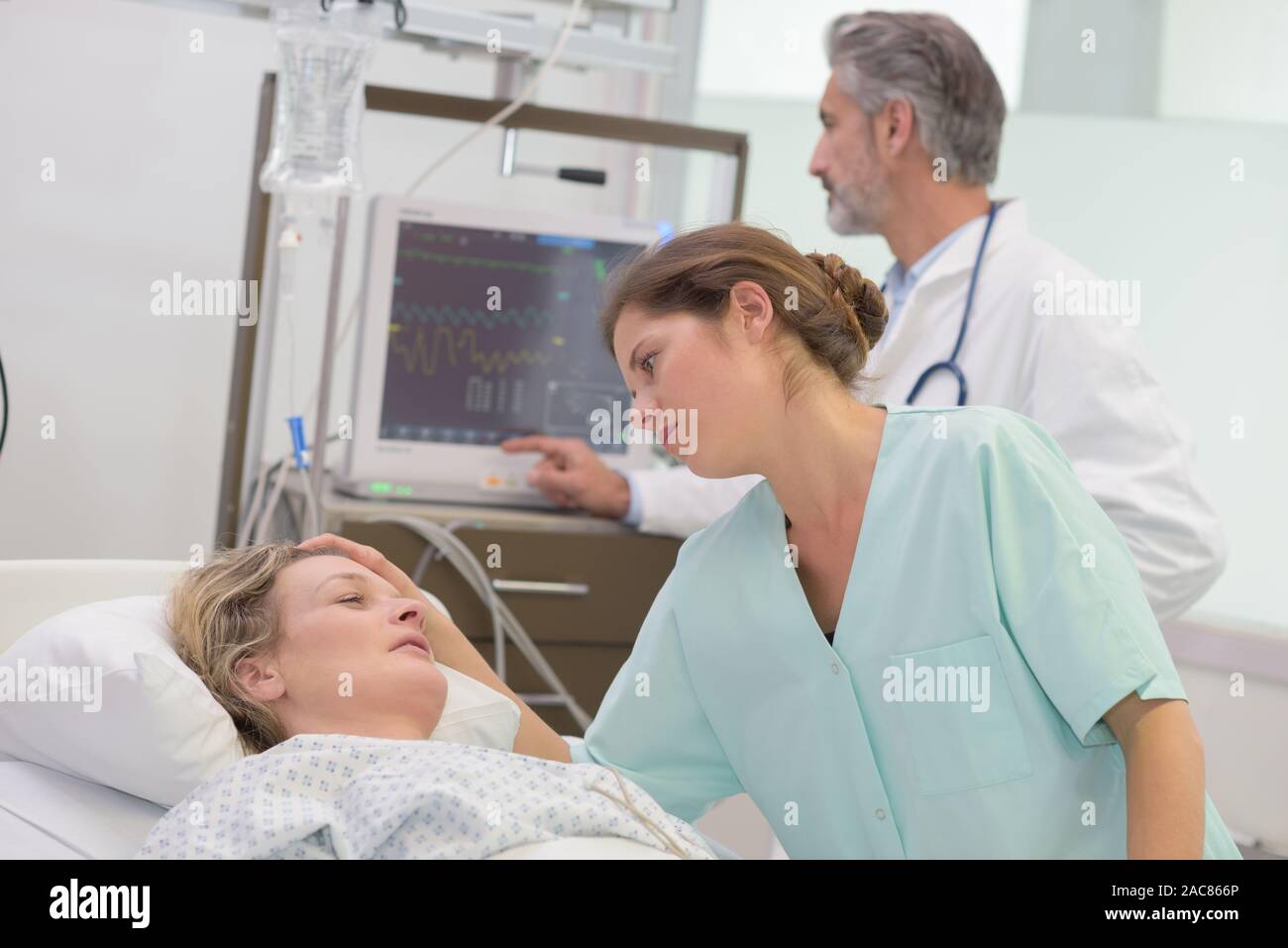 nurse comforting distressed patient Stock Photo - Alamy