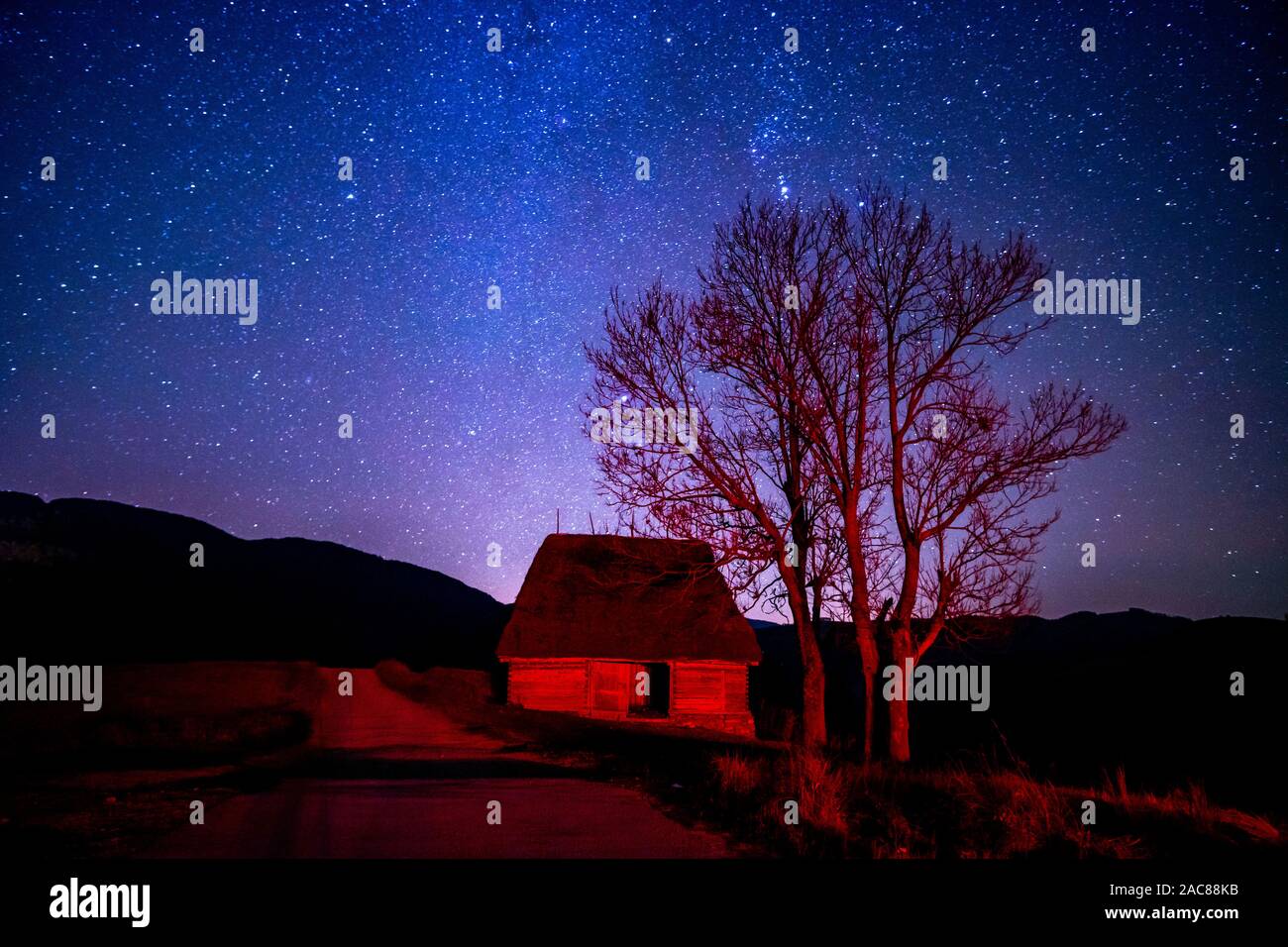 Romanian rural night landscape with hay shed under the starry skies, up ...
