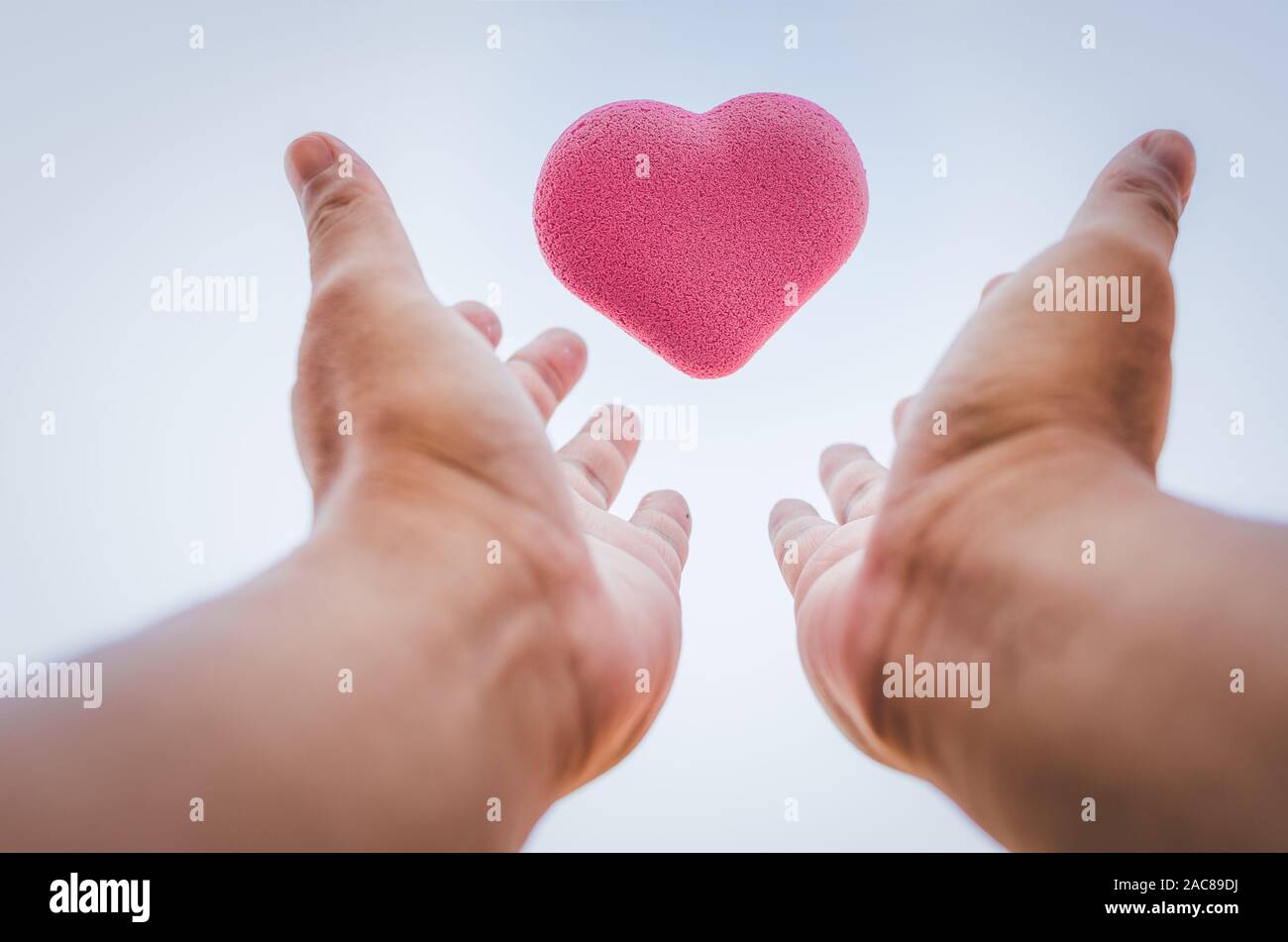 pink heart shaped bubble floating above human plam Stock Photo - Alamy