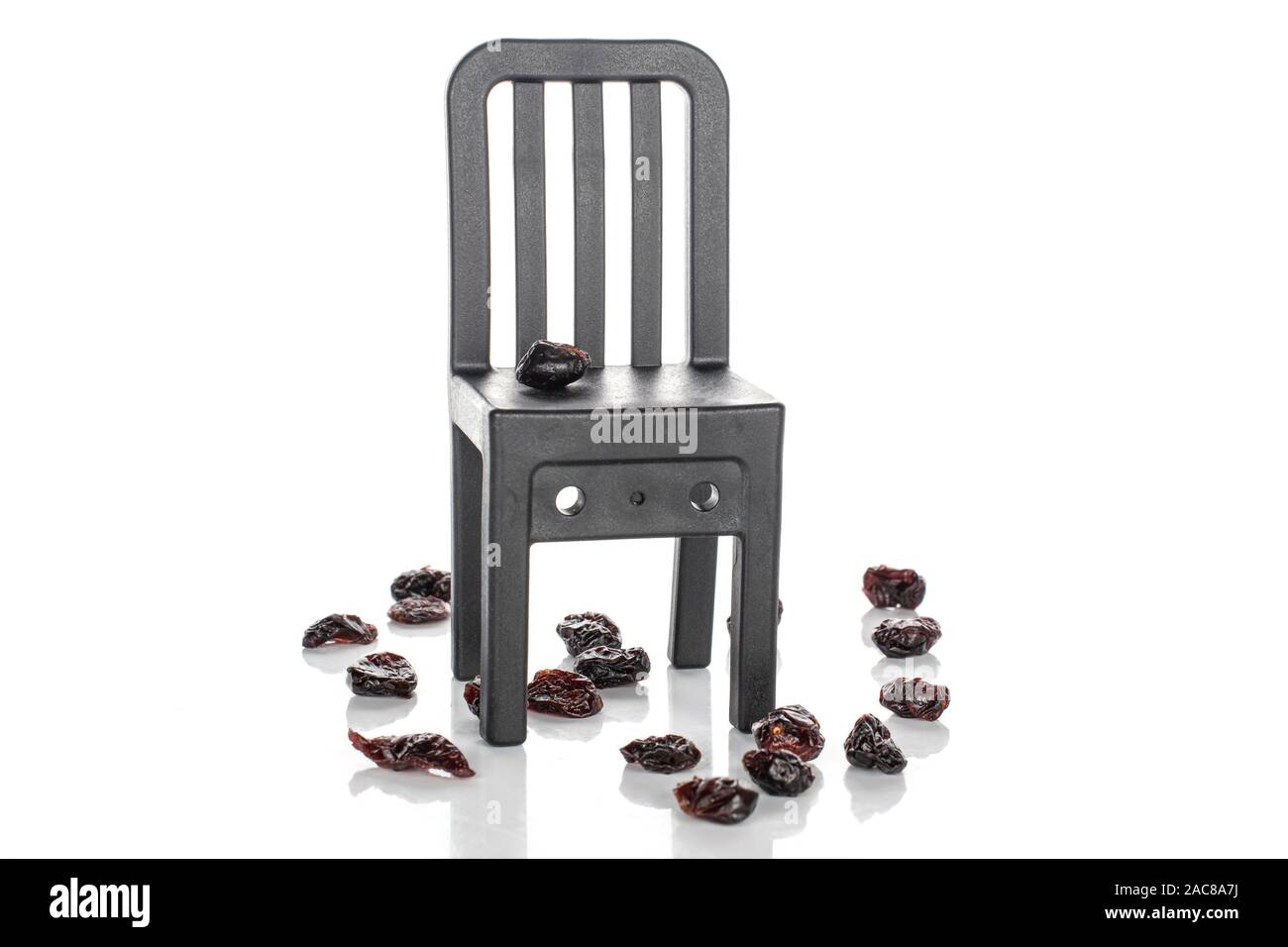 Lot of whole dried cowberry with black chair isolated on white ...