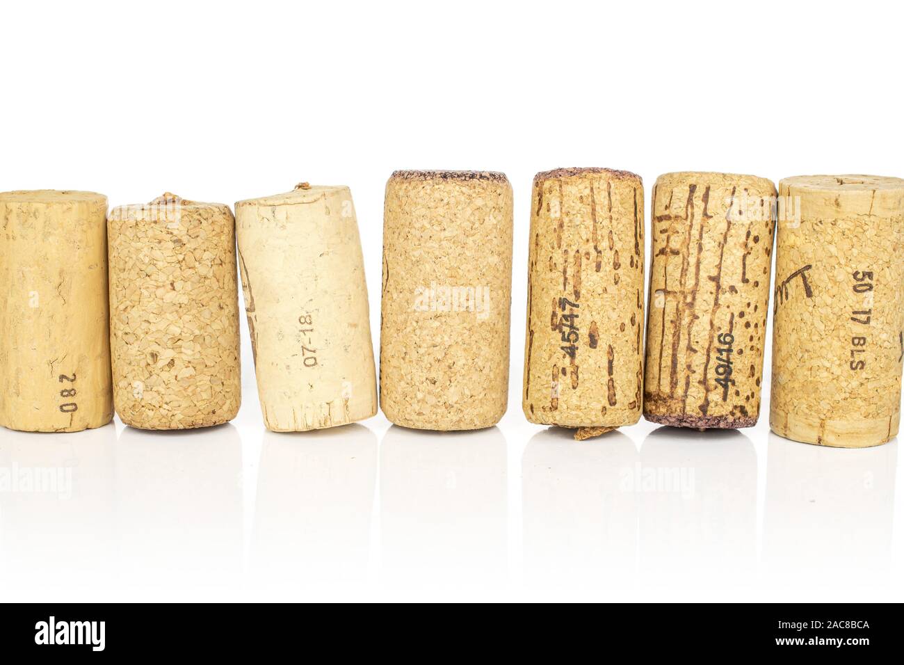 Group of seven whole common wine cork line isolated on white background ...