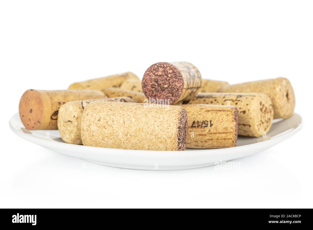 Lot of whole common wine cork on white ceramic plate isolated on white ...