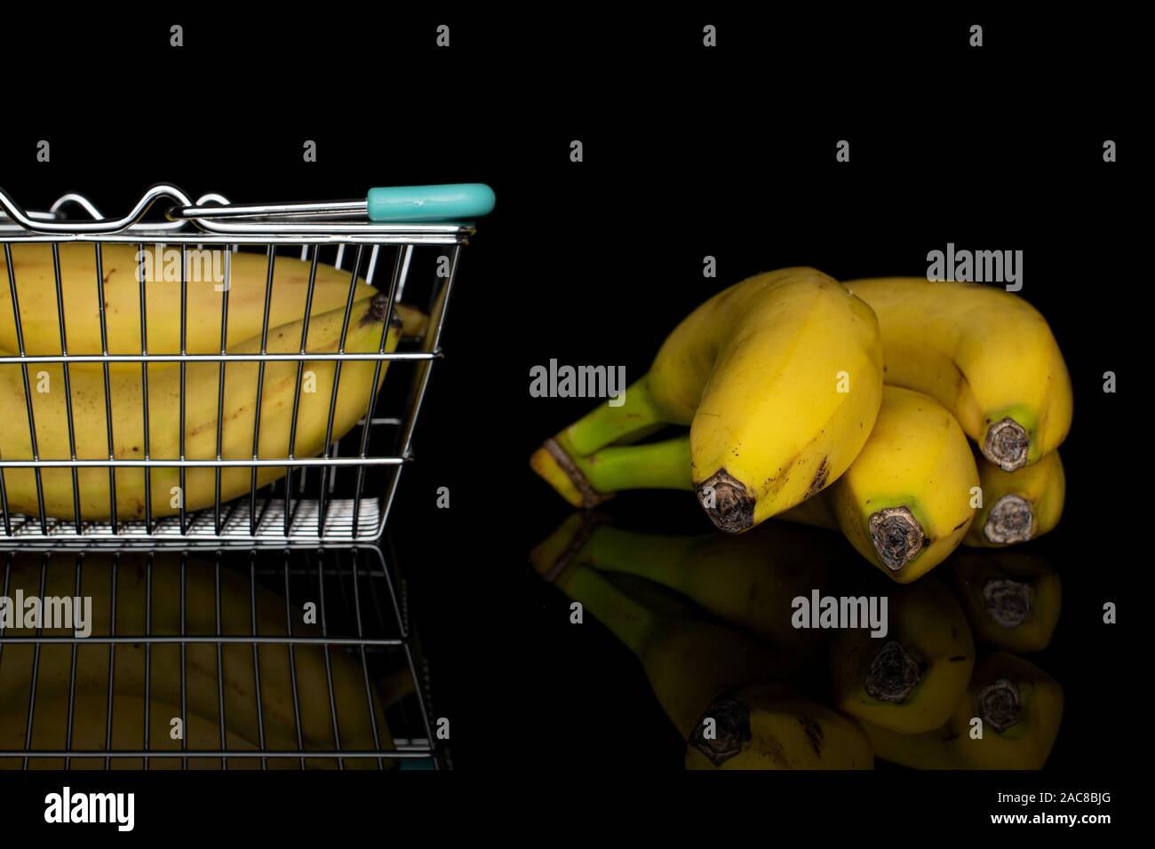 Group of six whole sweet yellow banana in shopping basket isolated on ...