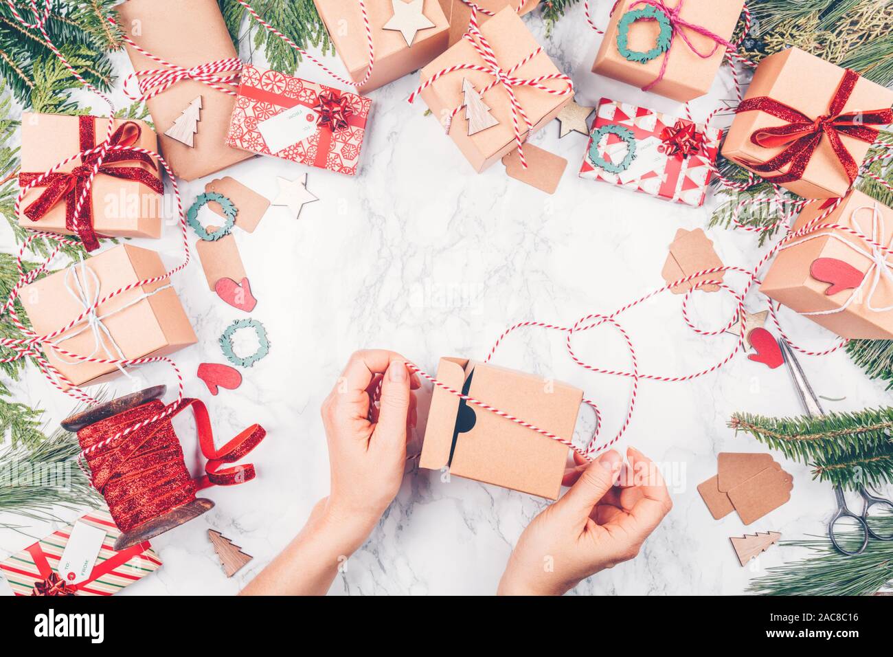 Craft boxes and wraps packed as Christmas gifts and red ribbons on ...