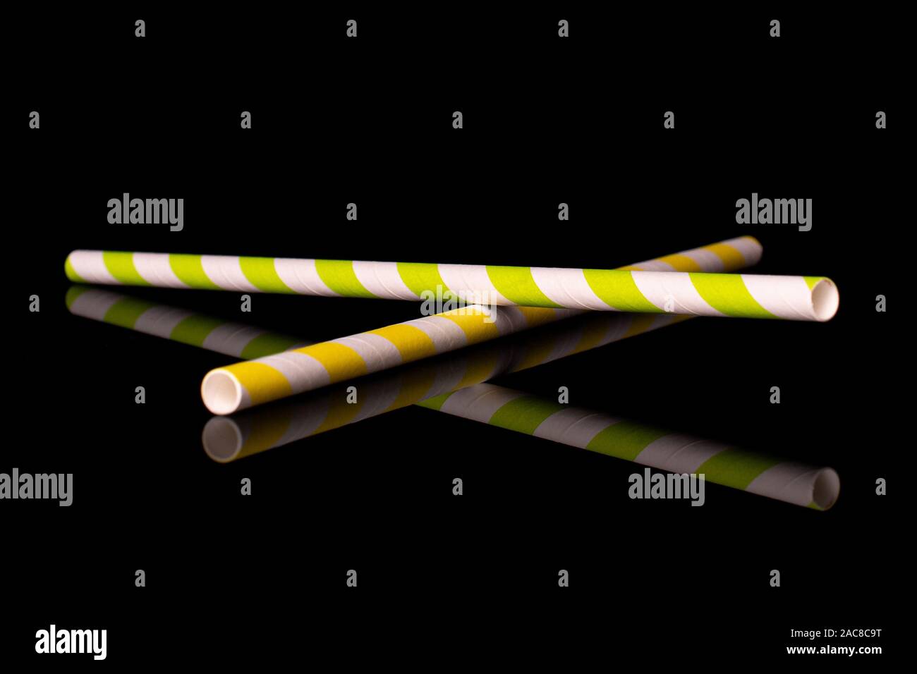 Group of two whole crossed paper straw isolated on black glass Stock ...