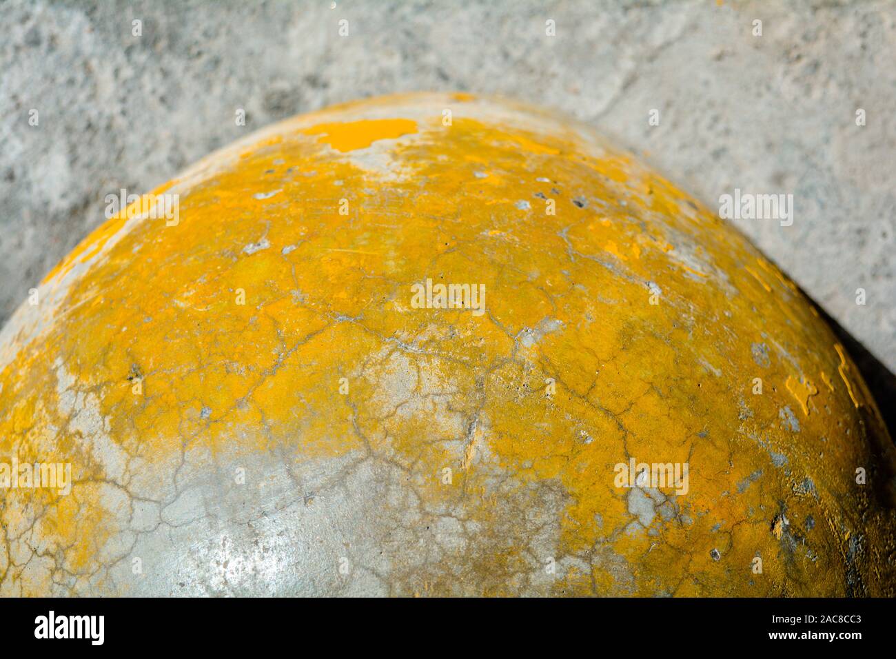 Yellow paint rough gray hemisphere limiter of parking from concrete ...