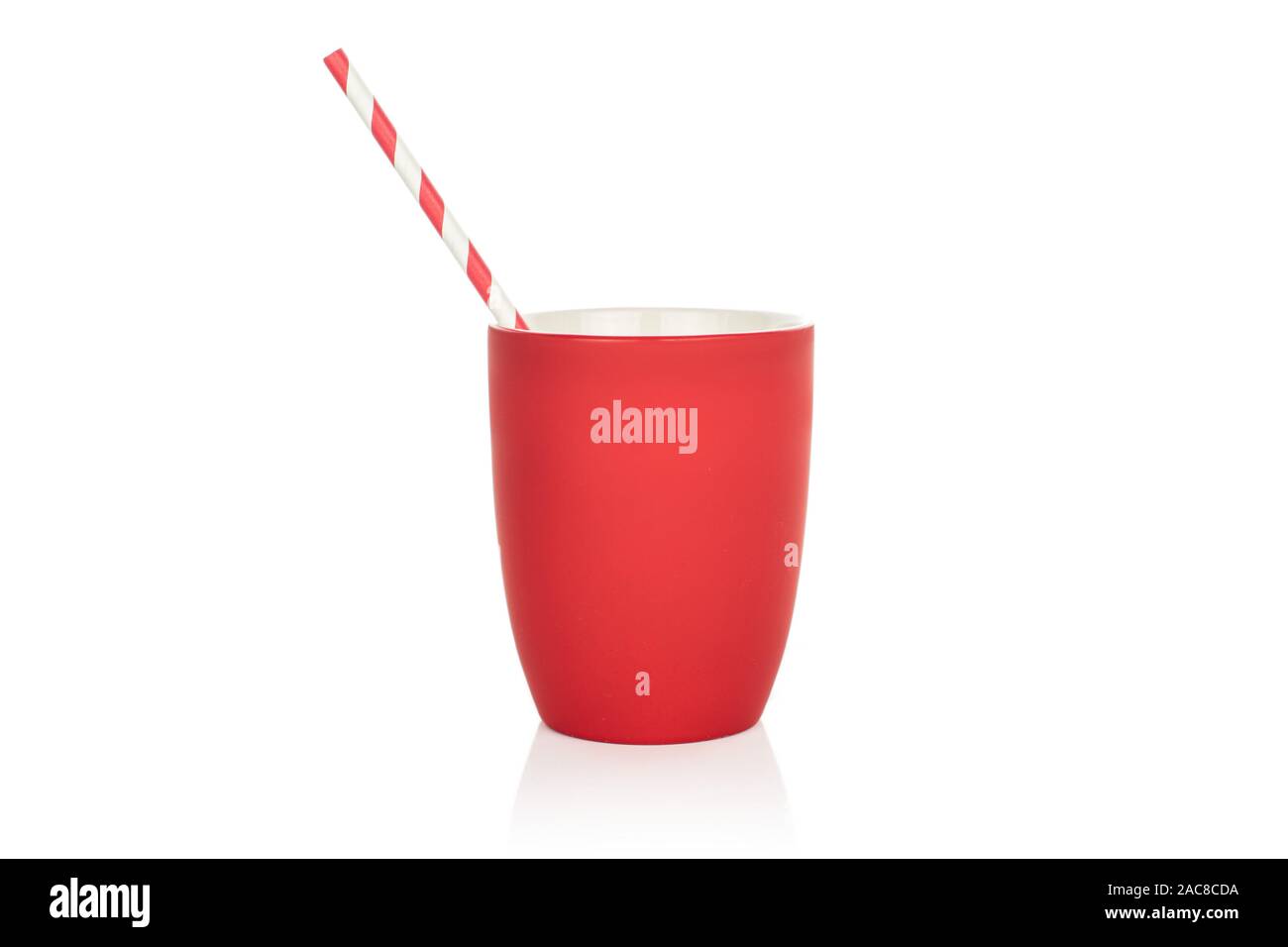 One whole paper straw with red ceramic cup isolated on white background ...