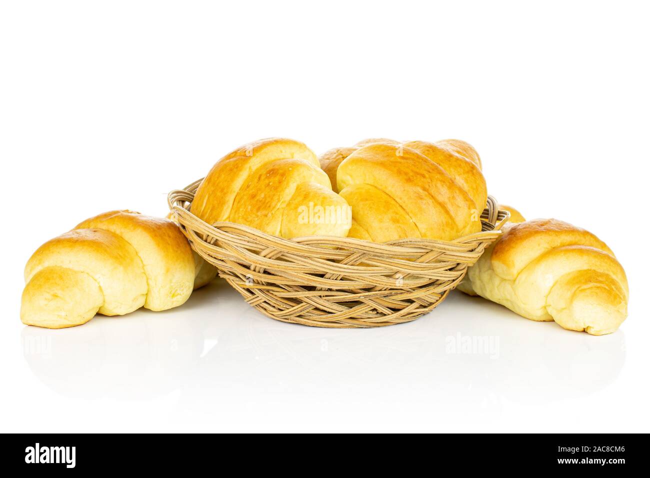Group of five whole sweet golden mini croissant in basket isolated on ...