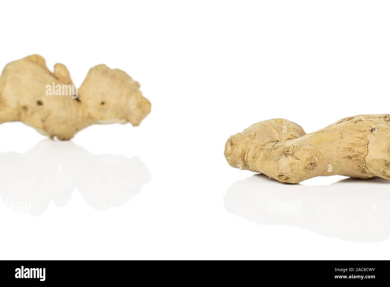 Group of two whole light fresh brown ginger isolated on white ...