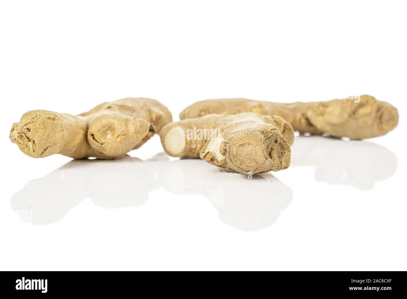 Group of three whole arranged fresh brown ginger isolated on white ...