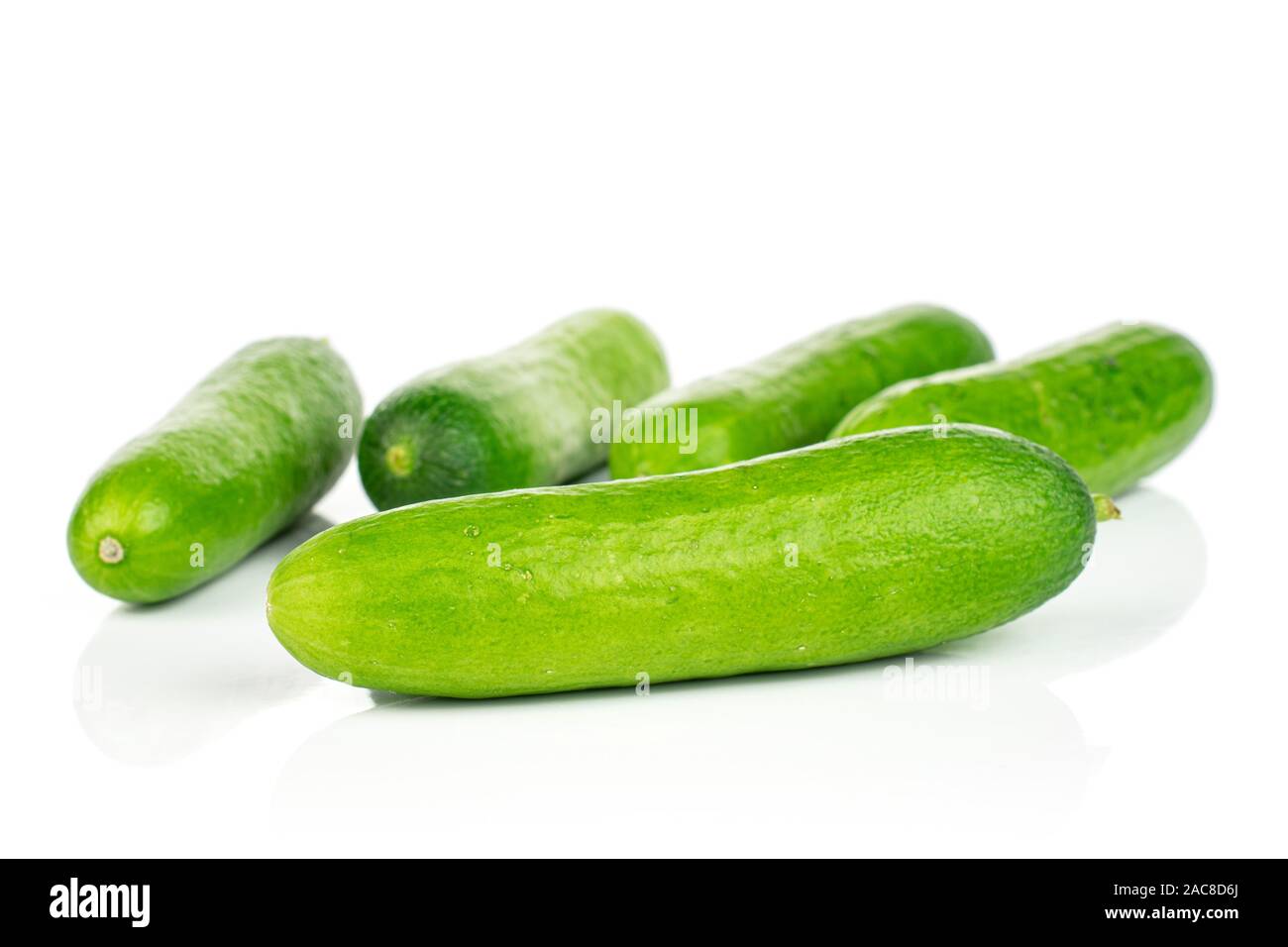 Group of five whole fresh green baby cucumber isolated on white ...