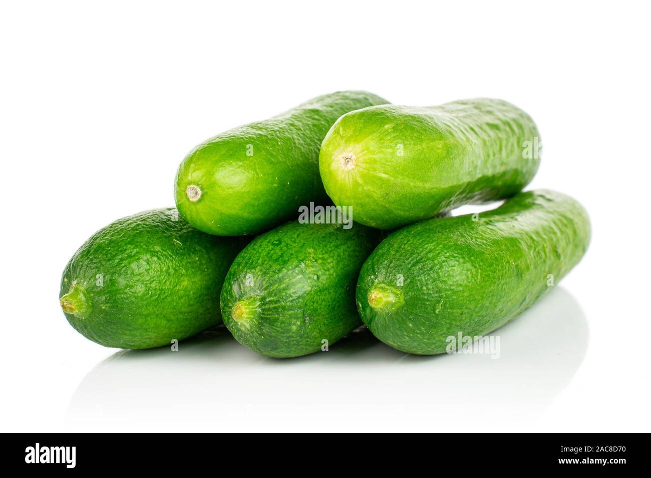 Group of five whole fresh green baby cucumber isolated on white ...