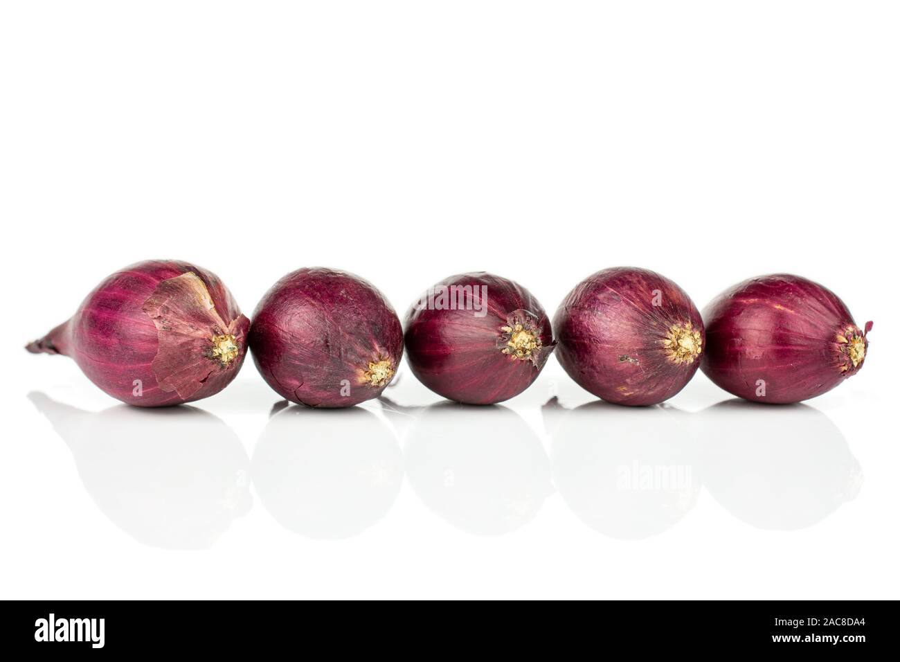 Group of five whole small red onion bulb isolated on white background ...