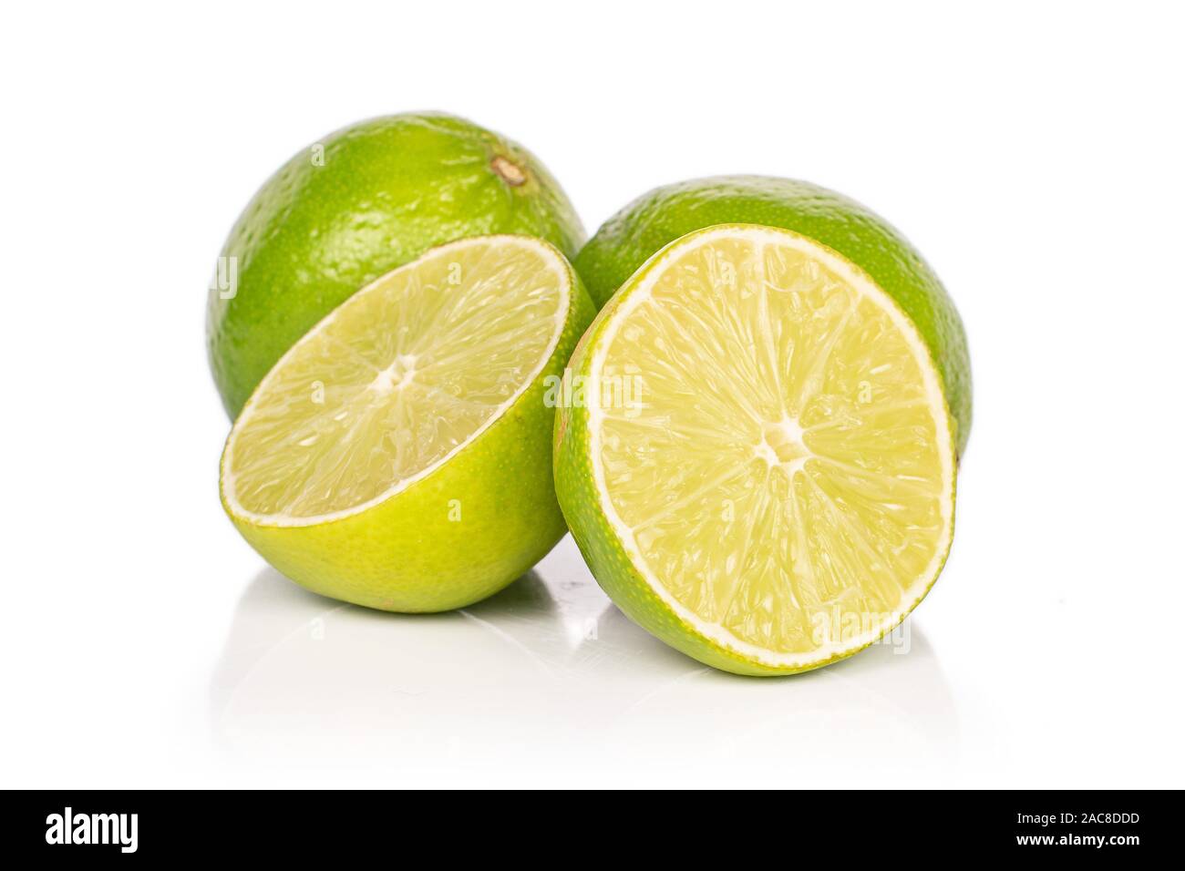 Group of two whole two halves of sour green lime isolated on white ...