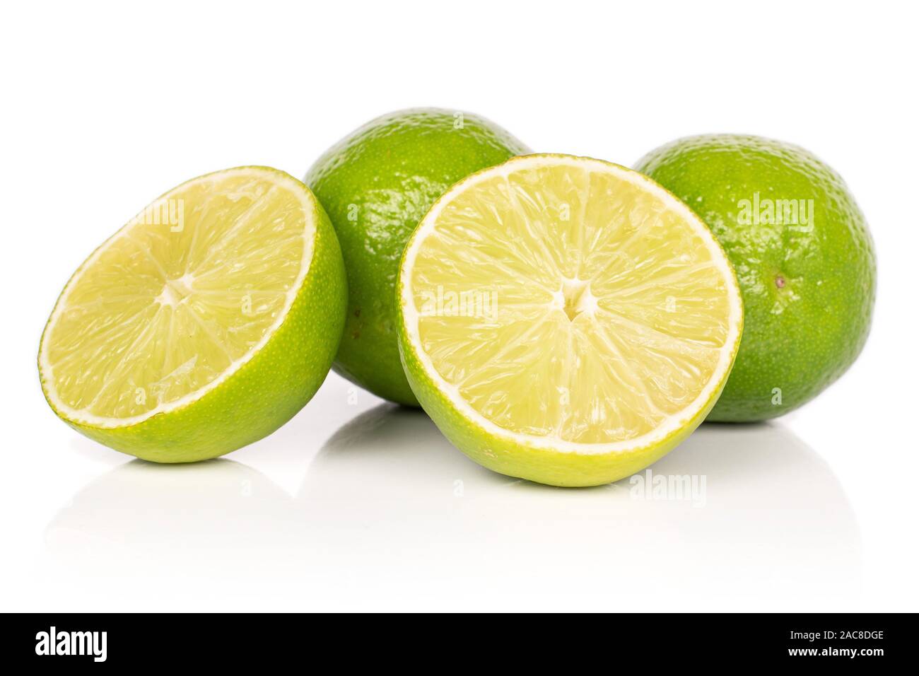 Group of two whole two halves of sour green lime isolated on white ...