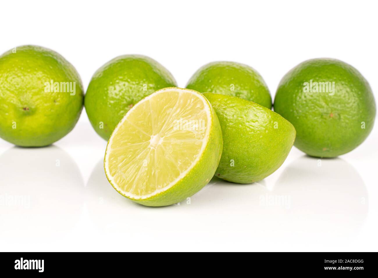 Group of four whole two halves of sour green lime isolated on white ...