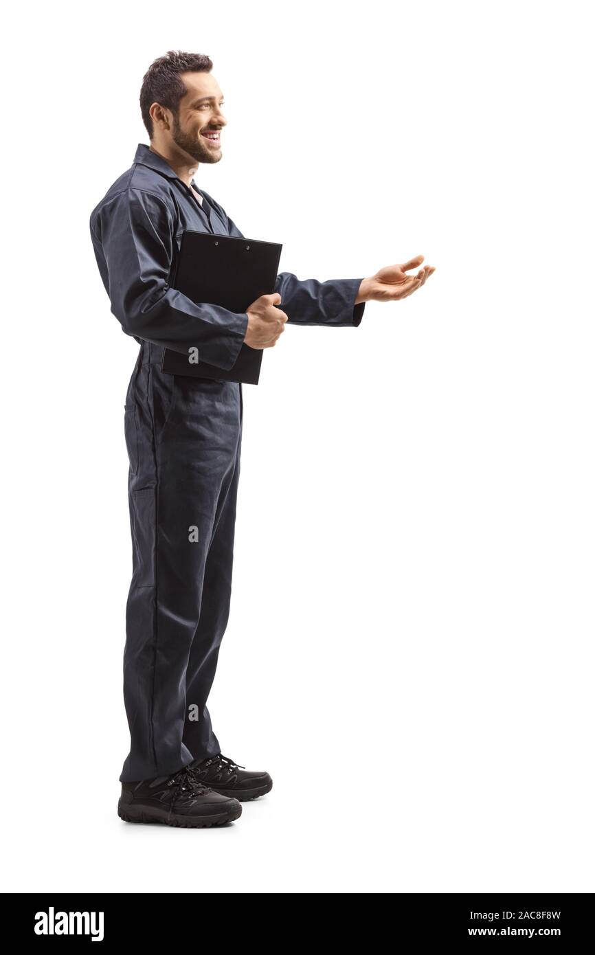 Full length profile shot of a male worker in a uniform standing and ...