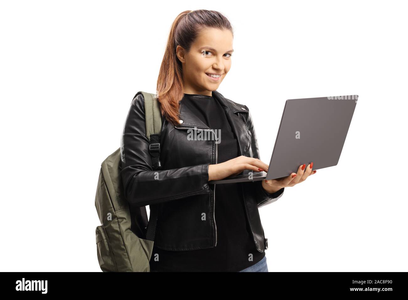 Female student holding a laptop and smiling at the camera isolated on ...