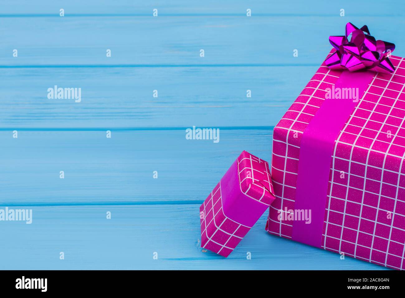 Purple checkered gift boxes on blue background Stock Photo - Alamy