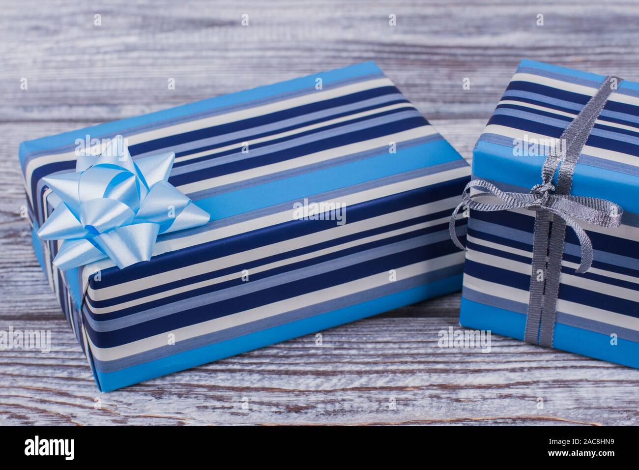 Striped gift box with blue bow Stock Photo - Alamy