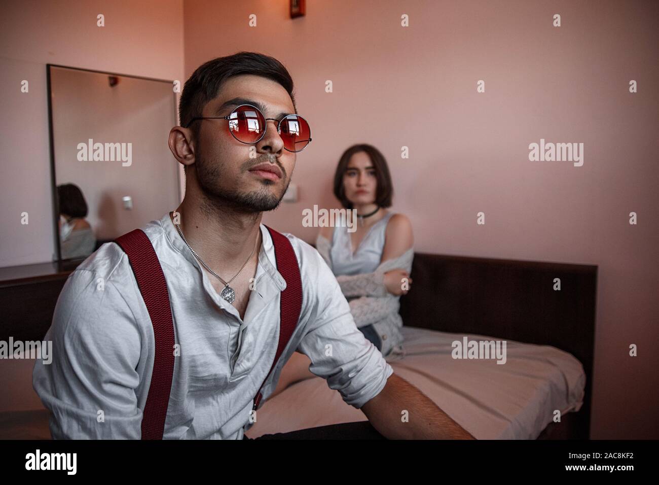 close-up portrait of a sad brooding brunette guy in sunglasses. in the ...
