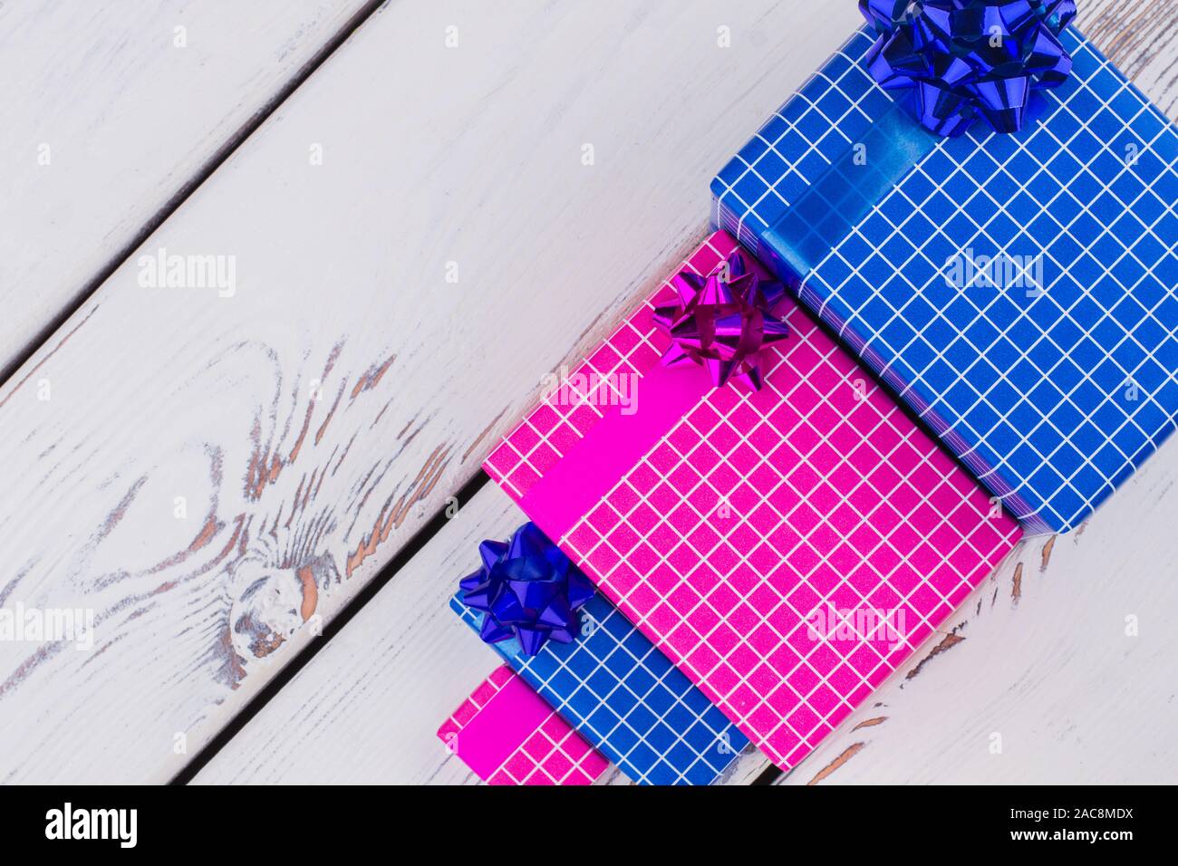 Different colors gift boxes on wooden background Stock Photo - Alamy
