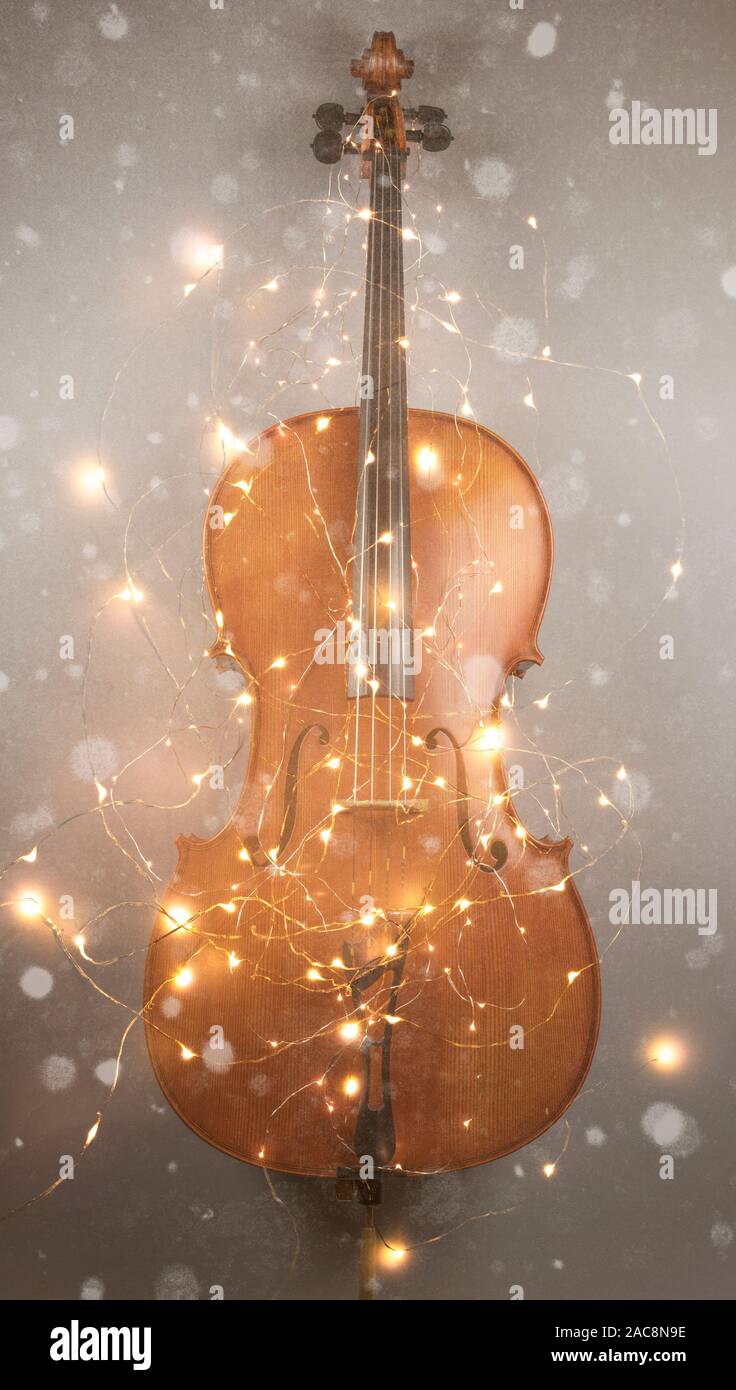 Festive holiday cello with fairy lights and snow Stock Photo - Alamy