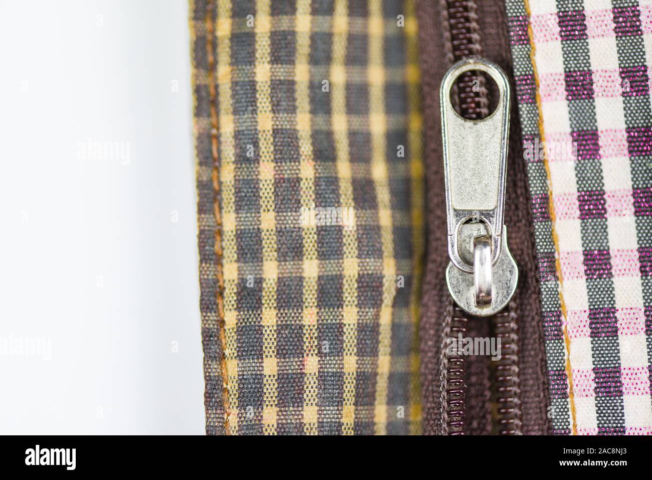 Metallic zipper for clothes / Close up open zip on handbag Stock Photo ...