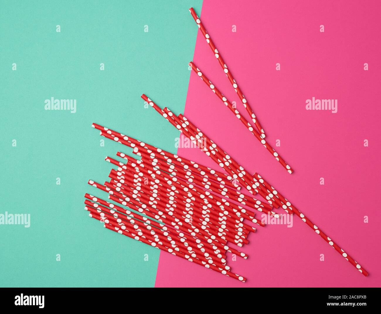 red paper tubes for a cocktail on a multi-colored background, concept ...