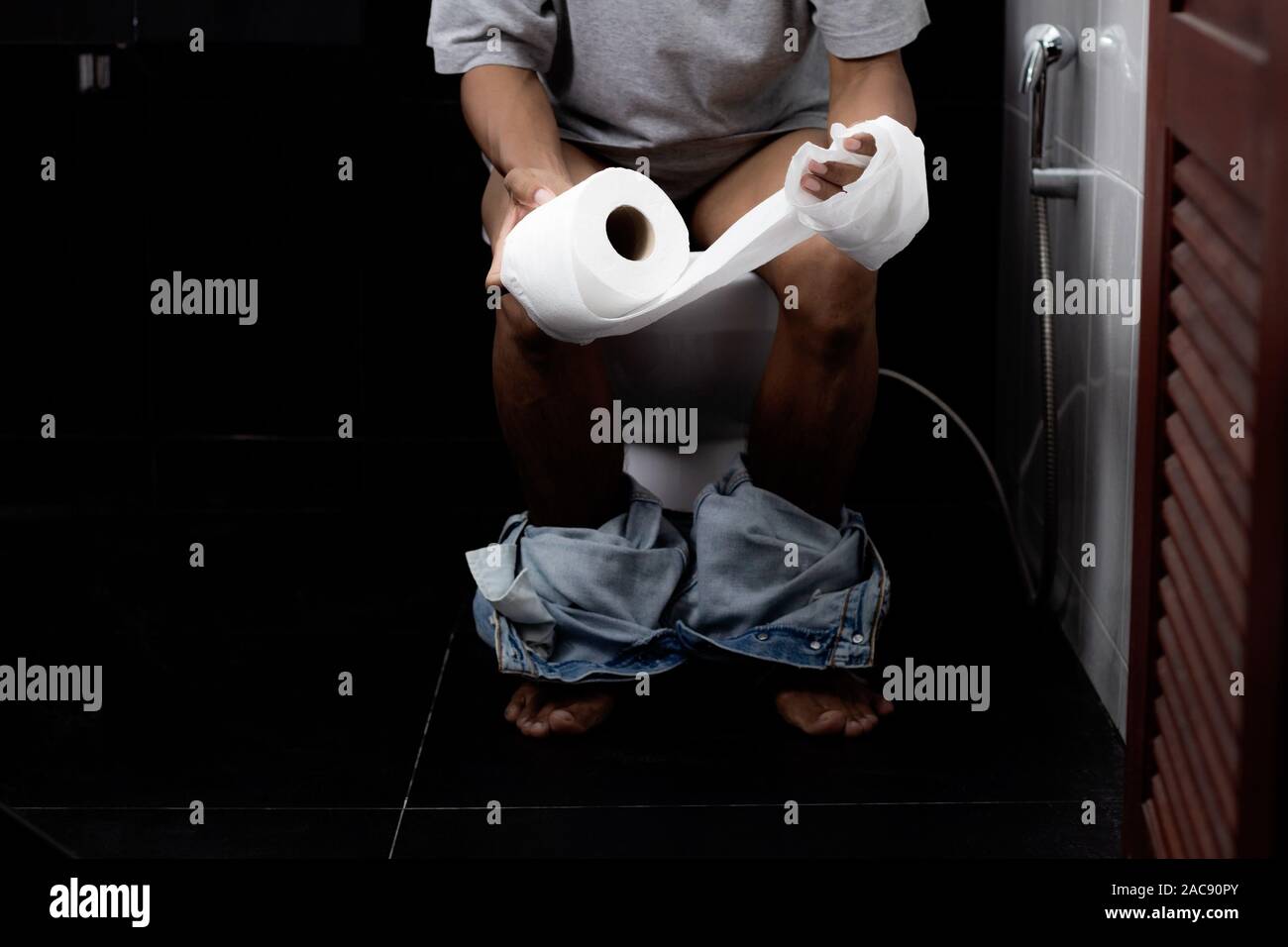 Asian man roll toilet paper hi-res stock photography and images - Alamy