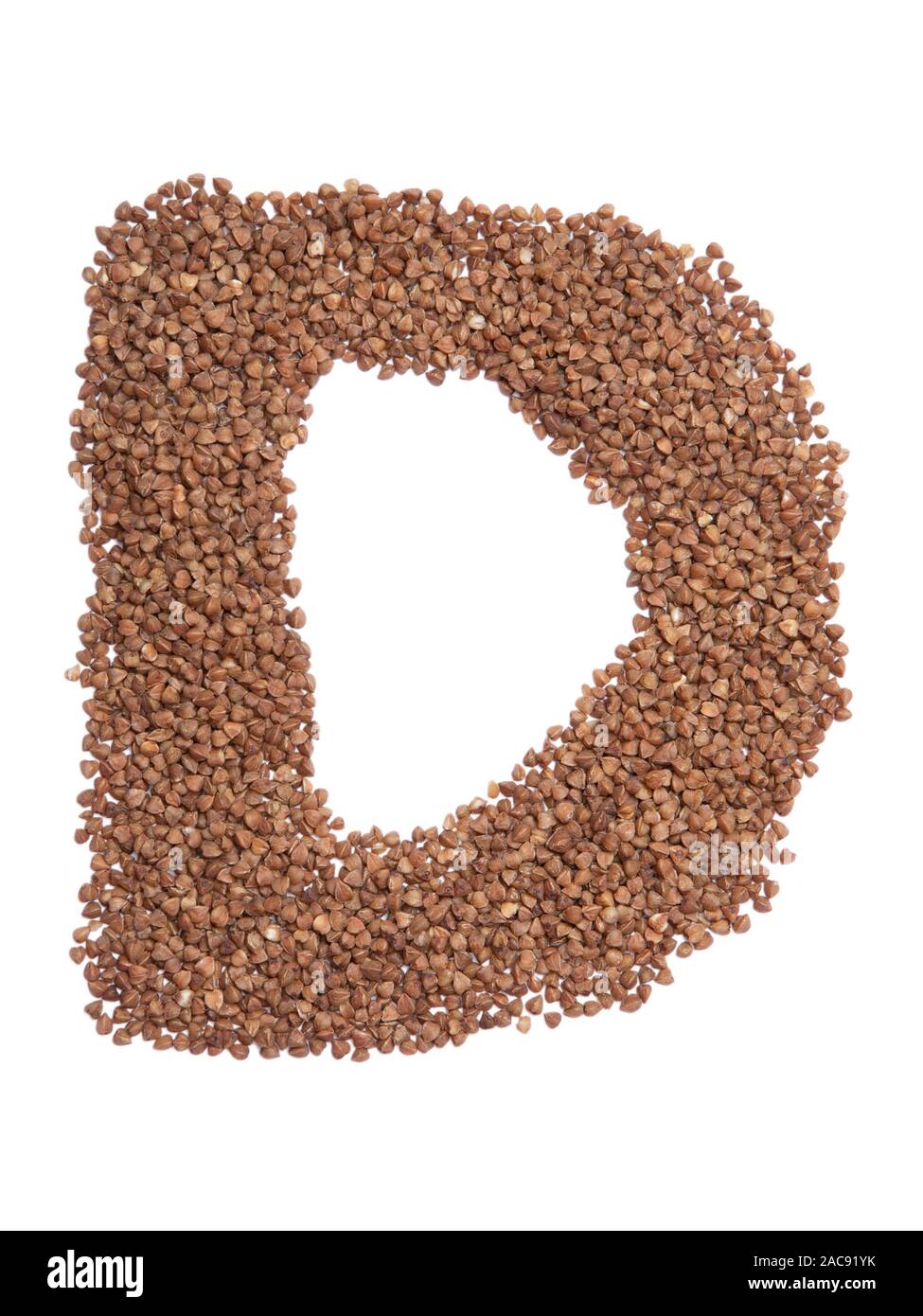 Letter D of the English alphabet from brown dry buckwheat on a white ...