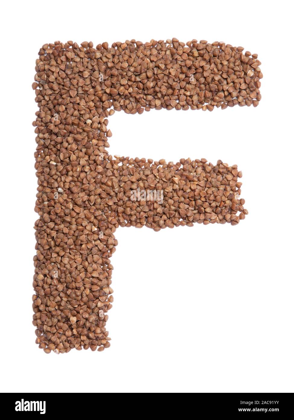 Letter F of the English alphabet from brown dry buckwheat on a white ...