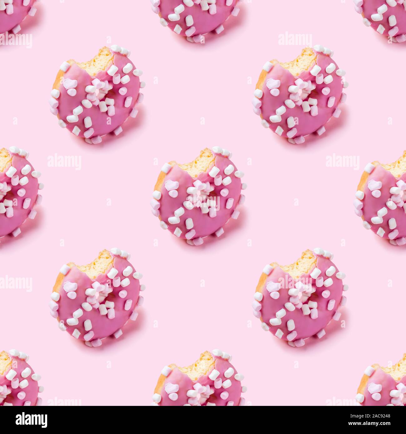 Seamless texture of Bitten pink icing donut with marshmallows ...