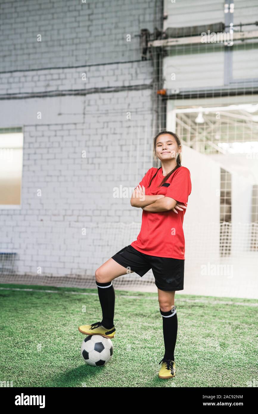 Happy young successful female football player in sports uniform ...