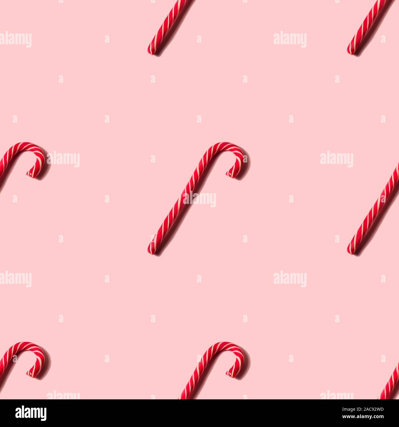 Seamless Christmas texture made of candy cane and shadow on pink ...