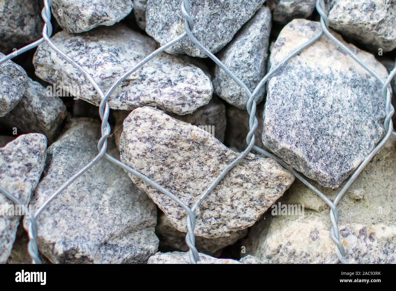 Stone gabion wall. Gabion - stones in wire mesh. Popular element of ...