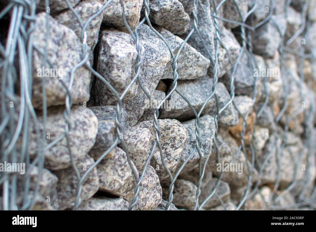 Stone gabion wall. Gabion - stones in wire mesh. Popular element of ...