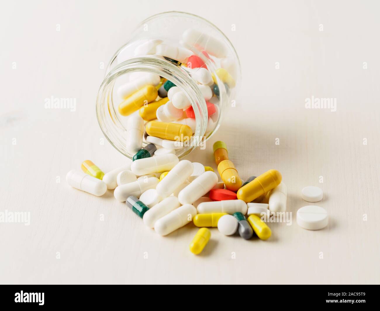 Glass open container with a medicament, jar with pills on white ...