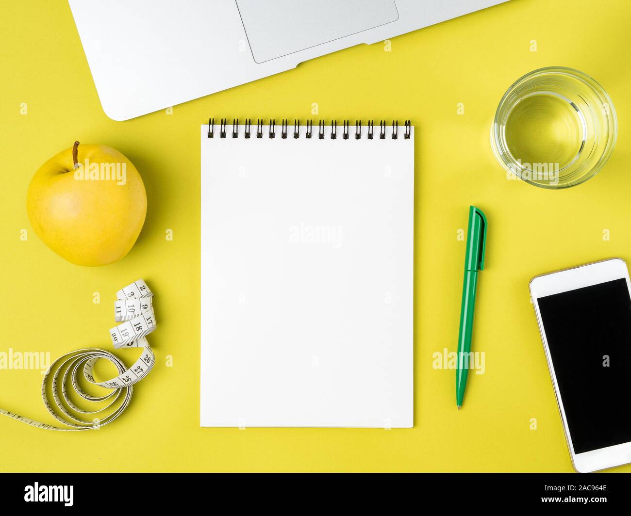 Blank Notebook page for Diet plan or menu, tape measure, water in glass ...