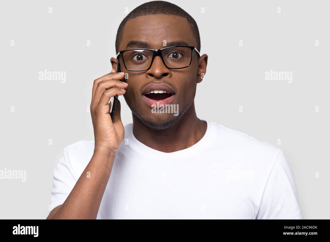 Surprised african american man using hi-res stock photography and ...